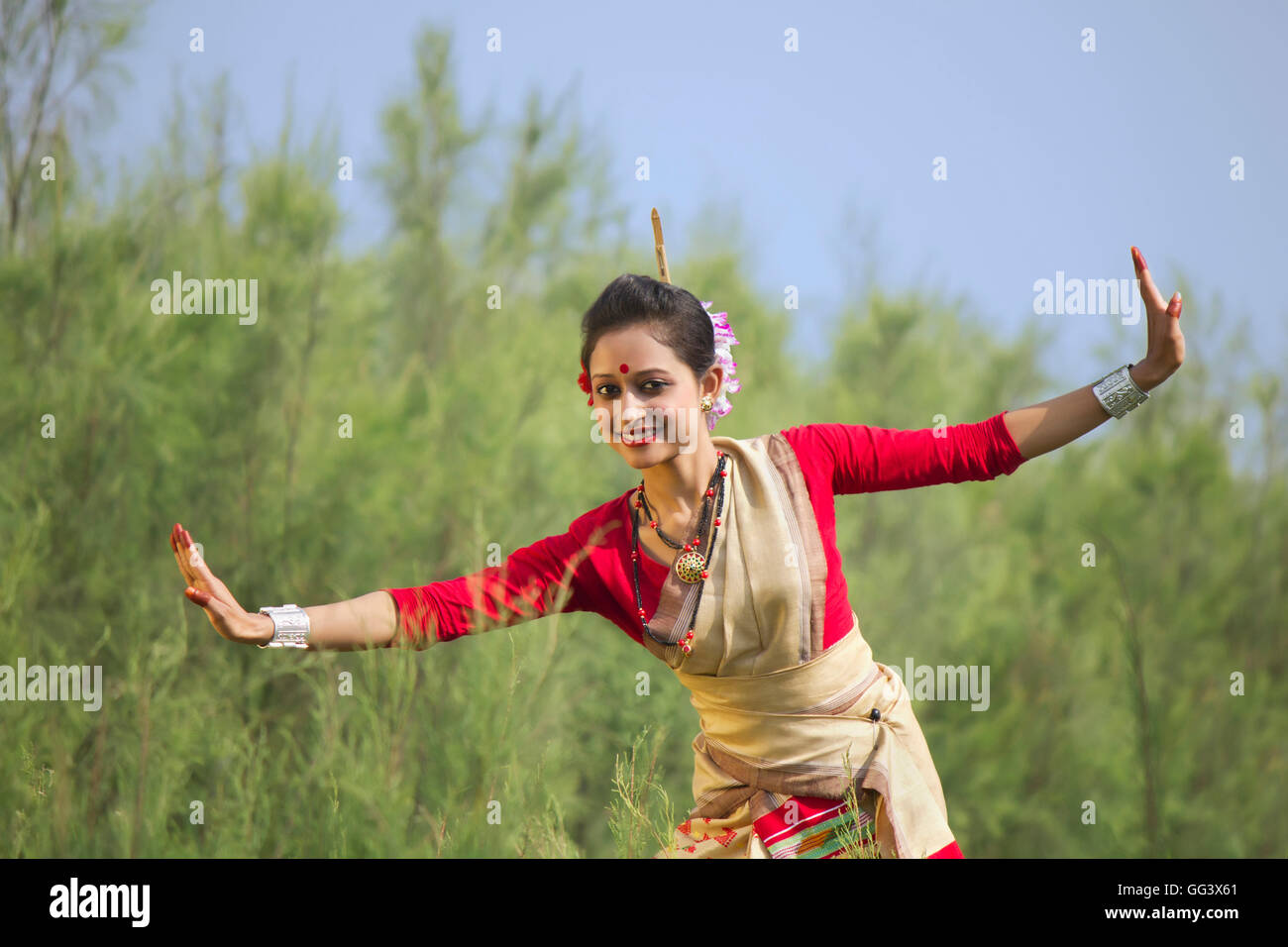 Portrait of woman doing Bihu dance Stock Photo - Alamy