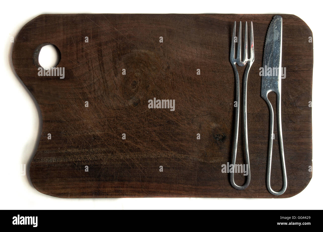 cutting board with silver knife and fork, ideal to place text in the ...