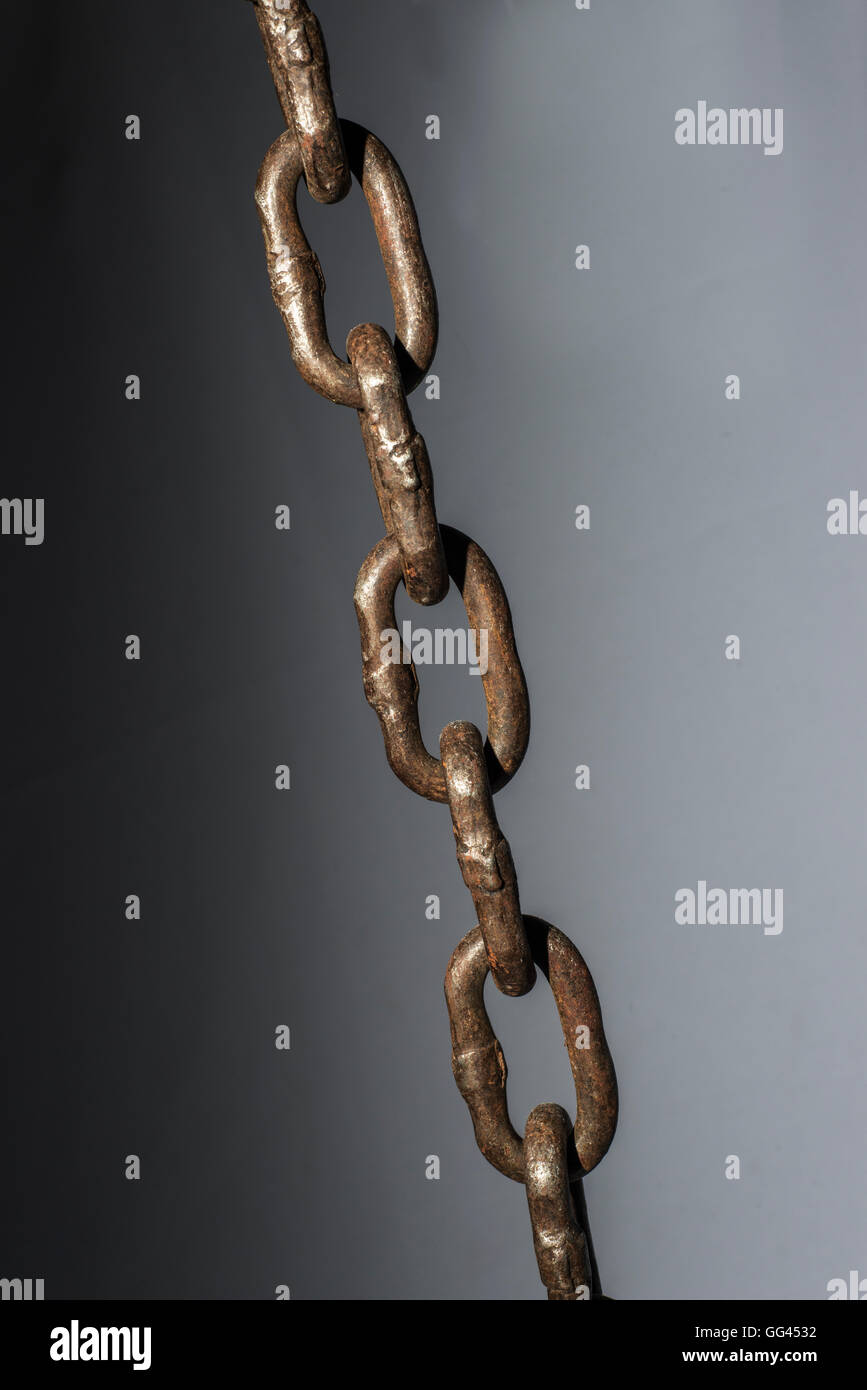 approach to an old chain on grey background Stock Photo - Alamy