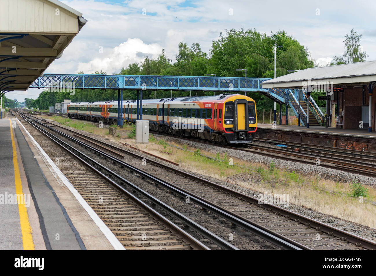 A class 159 diesel express train charges through Winchfield station on ...
