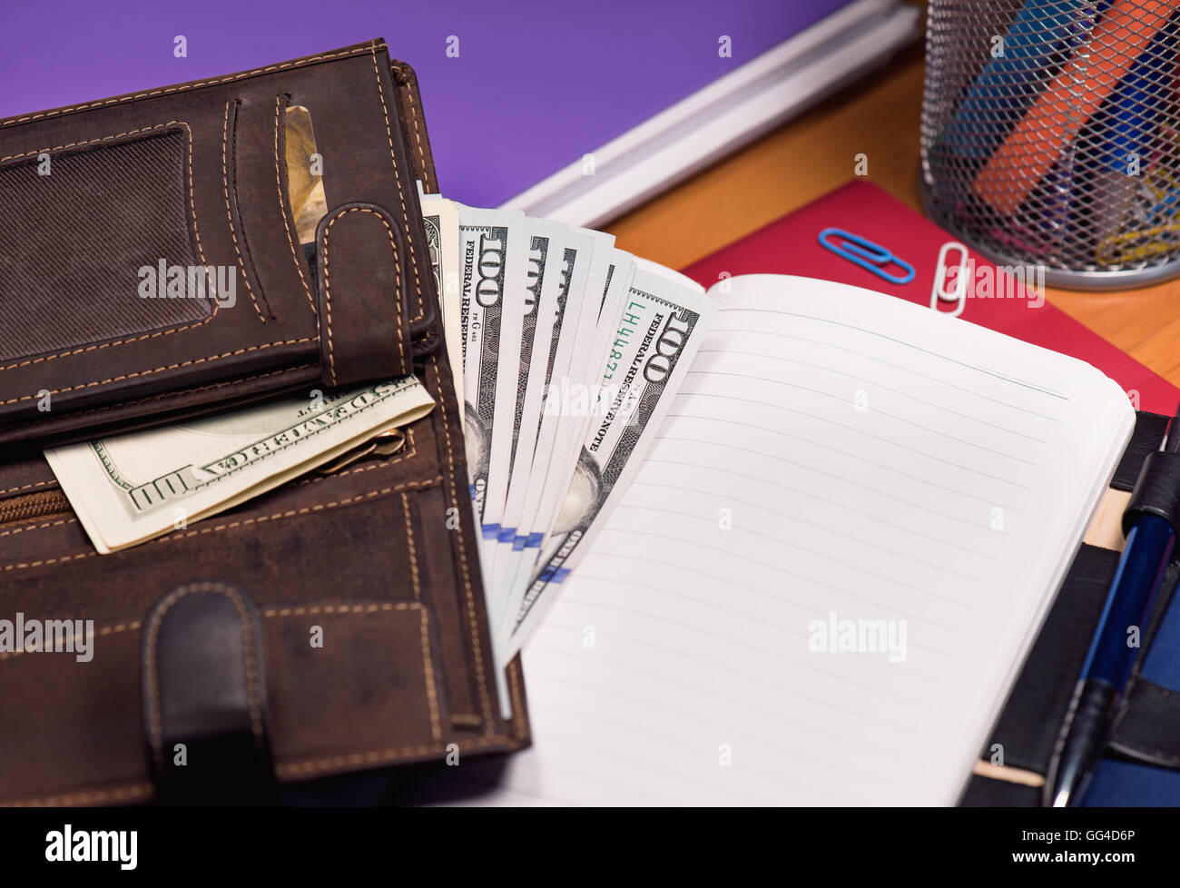 Notepad with dollar banknotes Stock Photo - Alamy