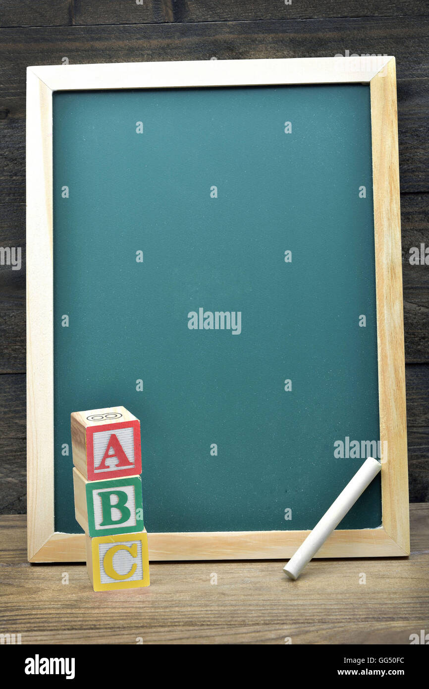 School board and word ABC on wooden table Stock Photo - Alamy