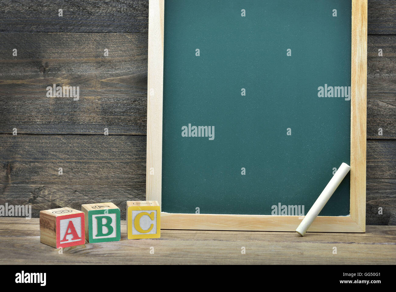 School board and word ABC on wooden table Stock Photo - Alamy