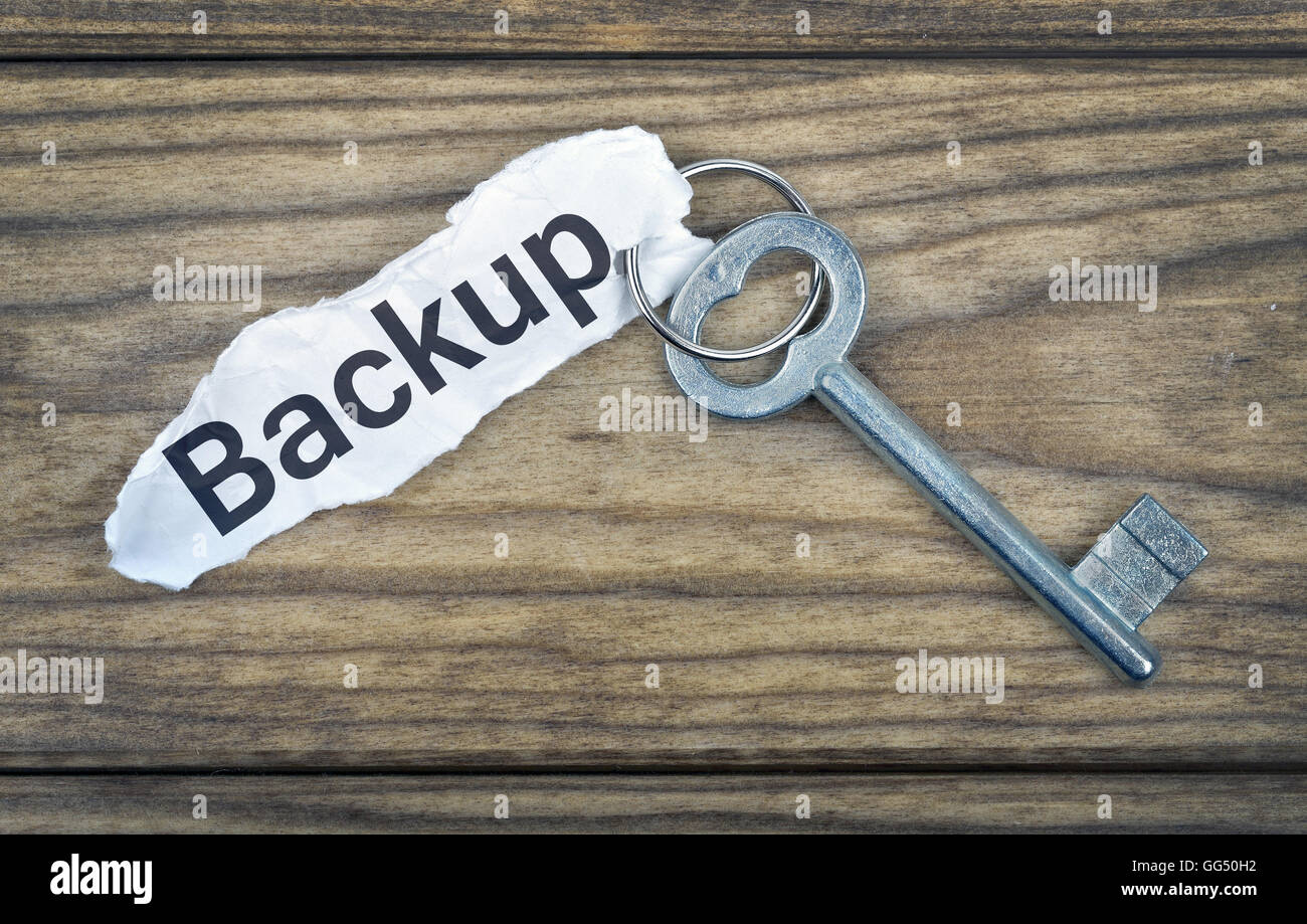 Key with message Backup on wooden table Stock Photo - Alamy