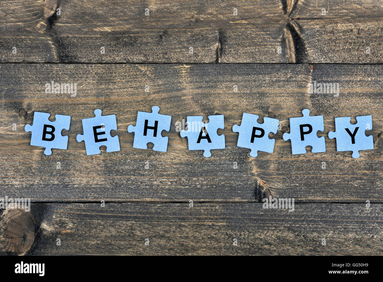 Puzzle pieces with word Be happy Stock Photo - Alamy