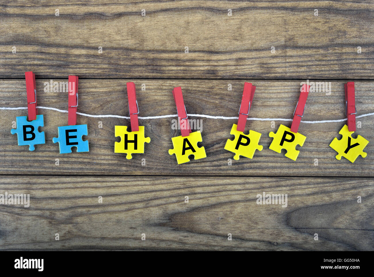 Puzzle pieces with word Be happy Stock Photo - Alamy