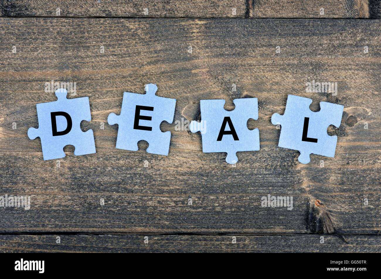 Puzzle pieces with word Deal Stock Photo - Alamy
