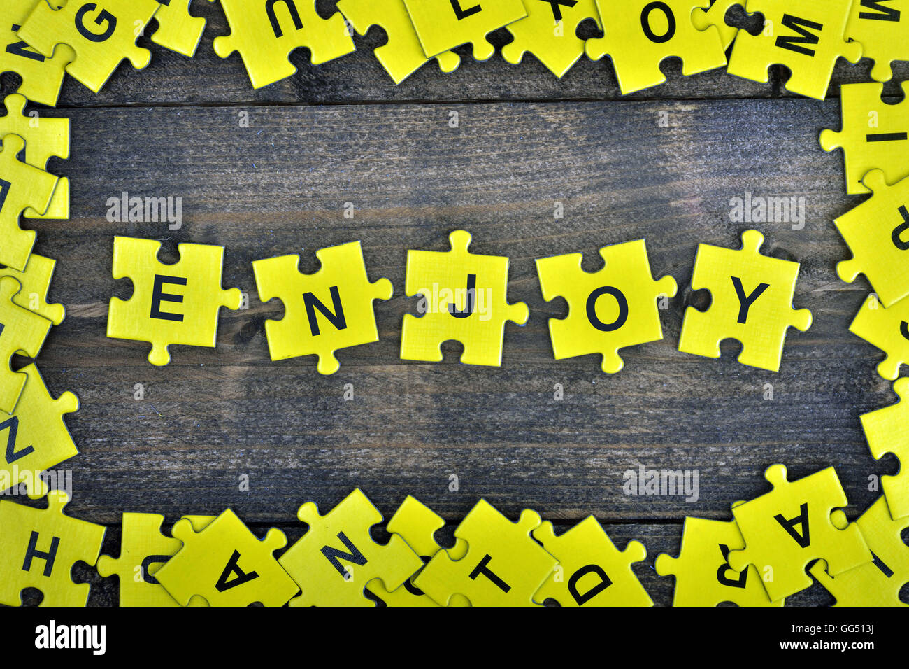 Puzzle pieces with word Enjoy Stock Photo - Alamy