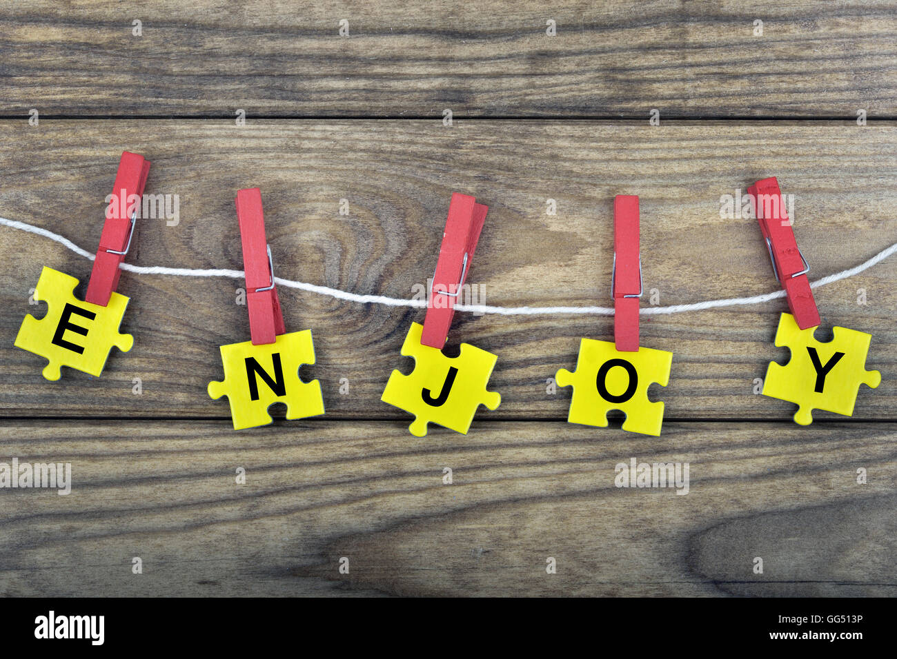 Puzzle pieces with word Enjoy Stock Photo - Alamy