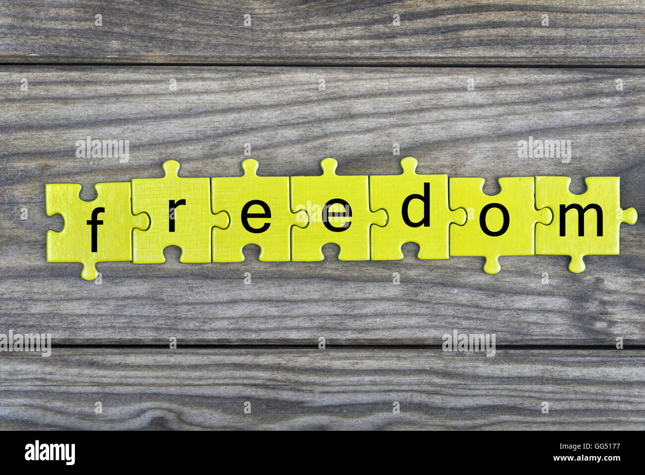 Puzzle pieces with word Freedom Stock Photo - Alamy