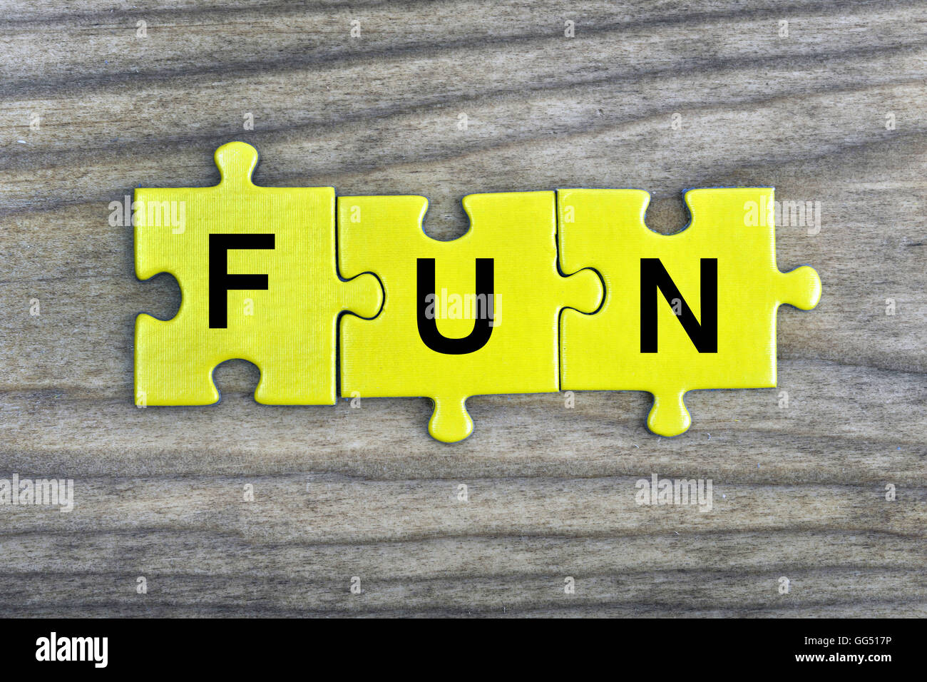 Puzzle pieces with word Fun Stock Photo - Alamy