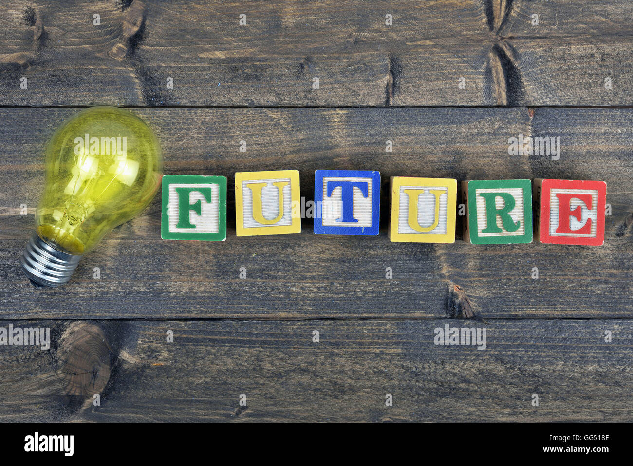 Bulb and word Future on wooden table Stock Photo - Alamy