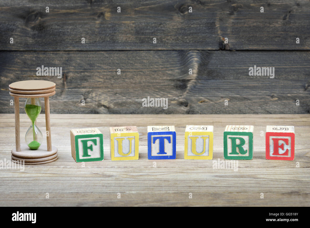 Hourglass and word future on wooden table Stock Photo - Alamy