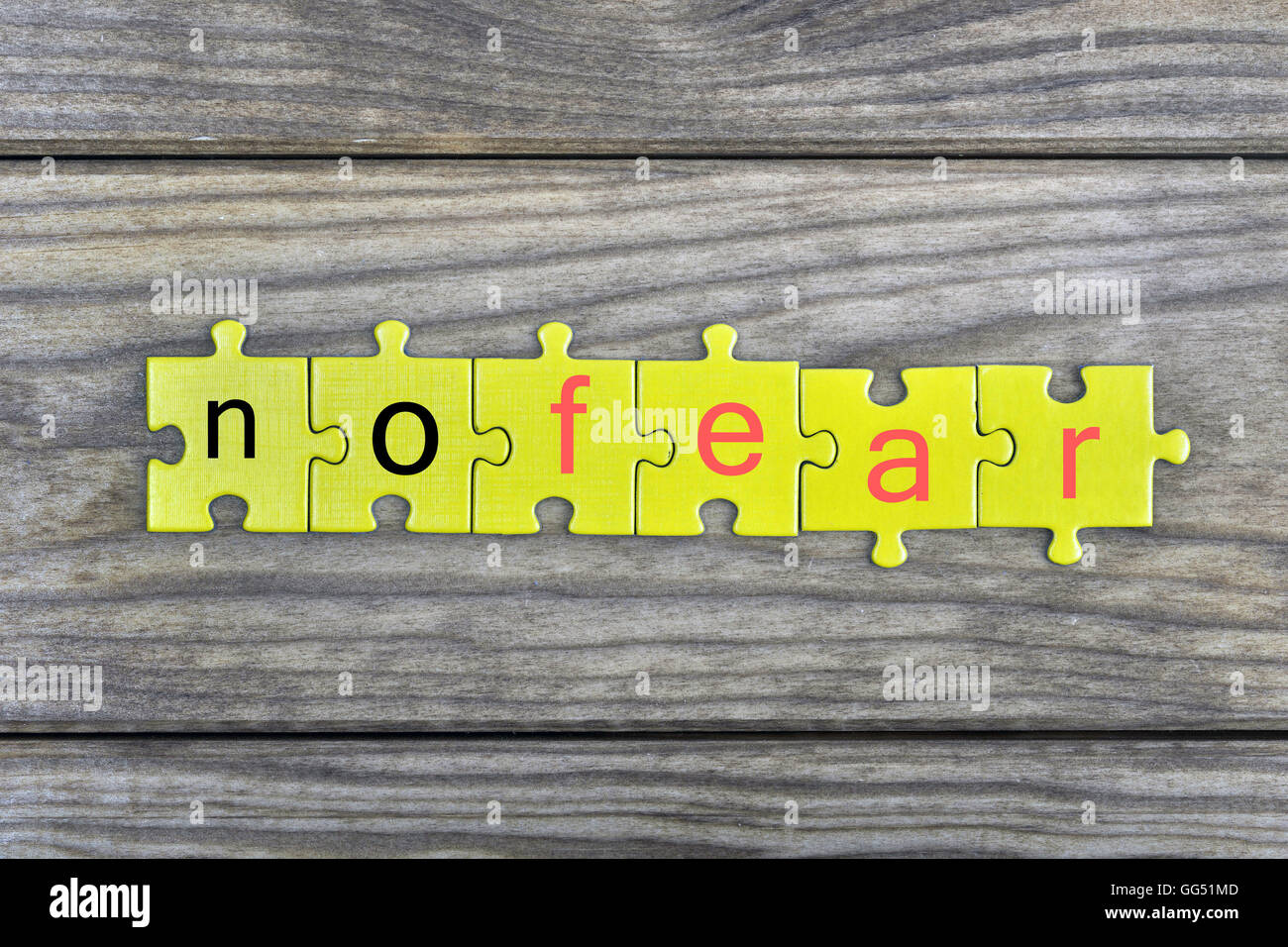 Puzzle pieces with word no fear Stock Photo - Alamy