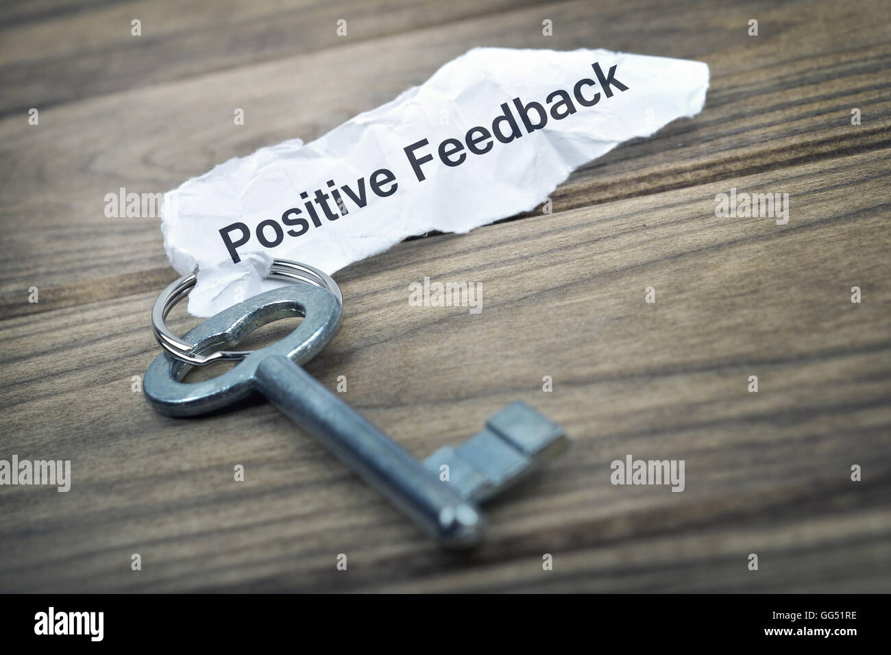 Key with message Positive Feedback on wooden table Stock Photo - Alamy