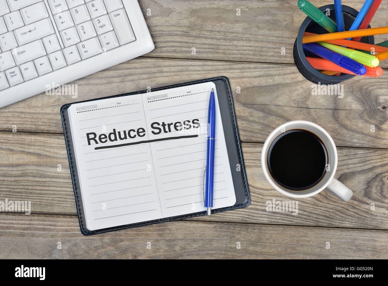 Reduce Stress message on notebook and coffee Stock Photo - Alamy