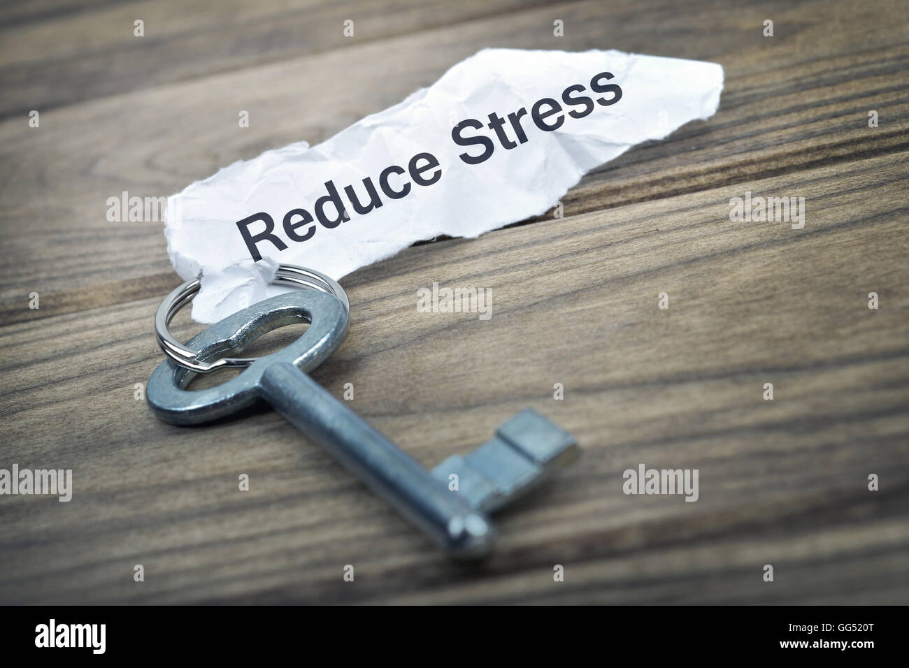 Key with message Reduce Stress on wooden table Stock Photo - Alamy