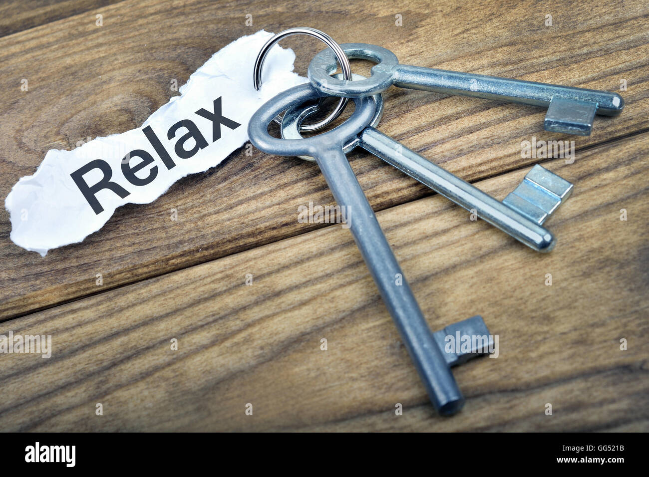 Key with message Relax on wooden table Stock Photo - Alamy