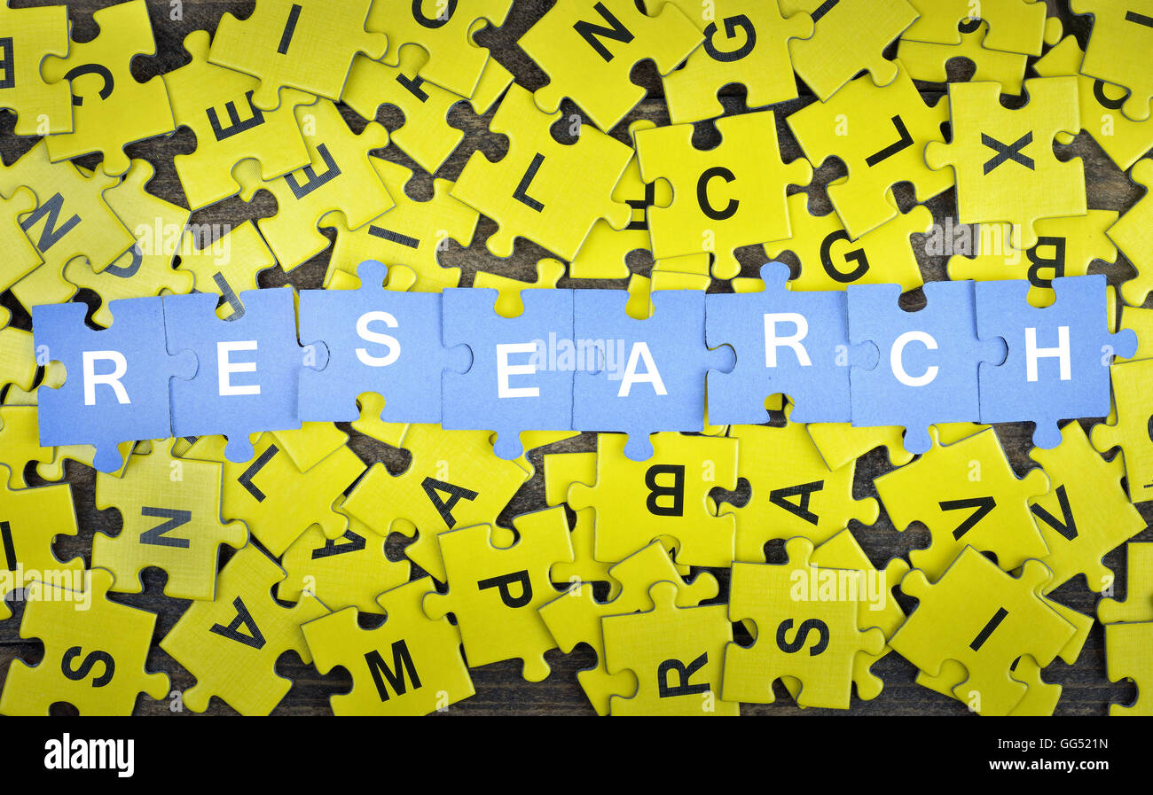 Puzzle pieces with word Research Stock Photo - Alamy