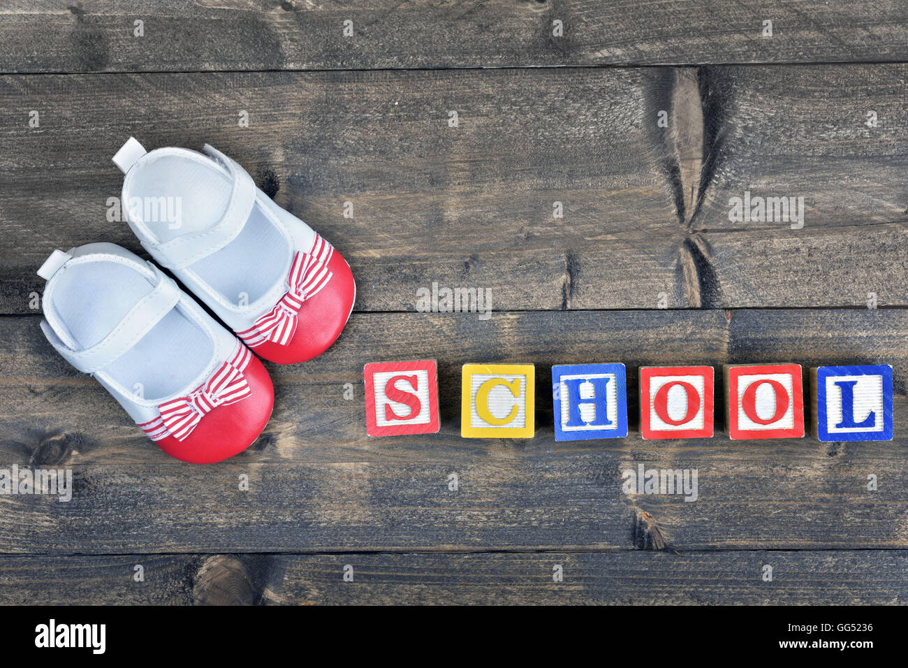 Kid shoes and word school on wooden table Stock Photo - Alamy