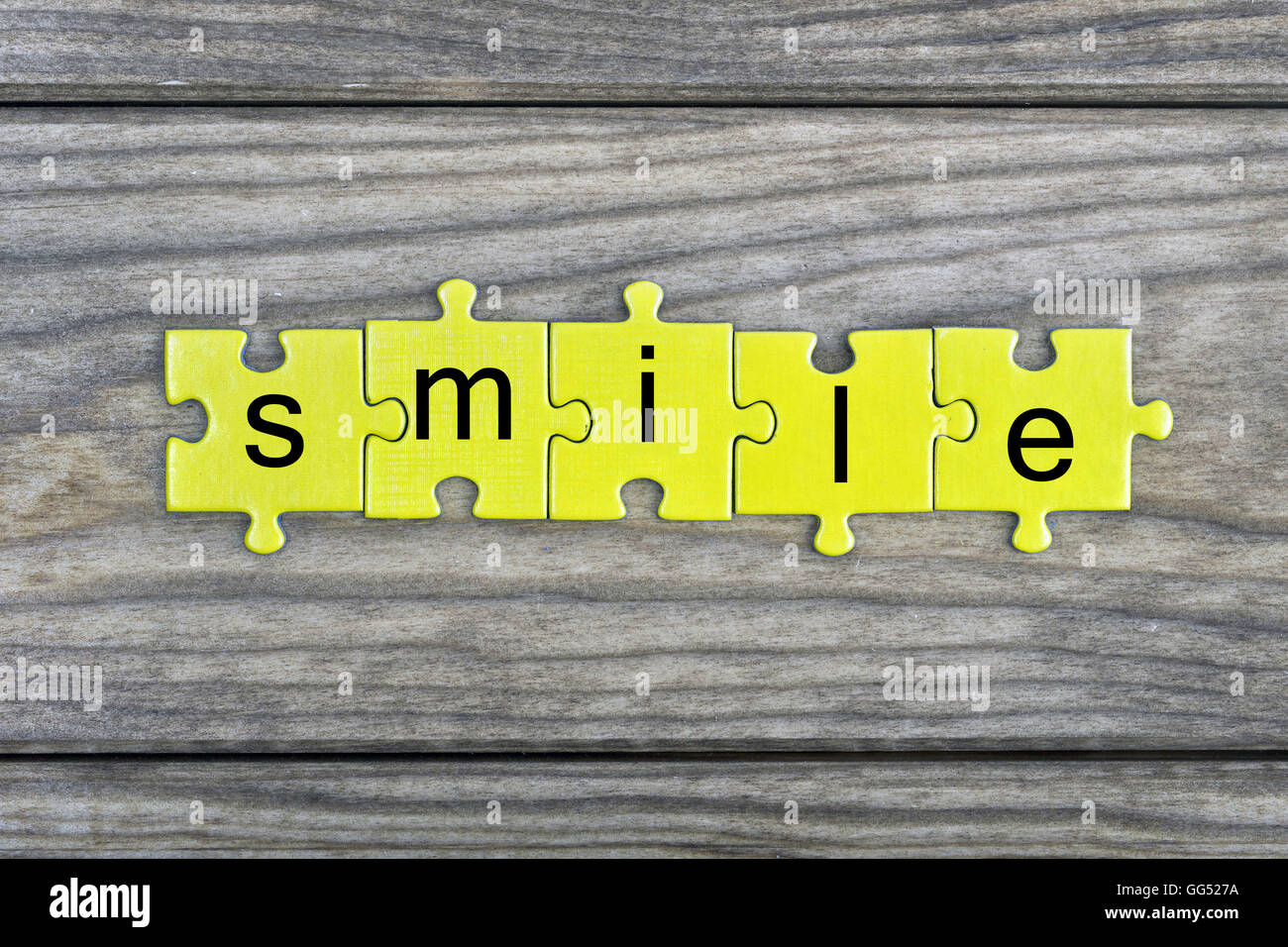 Puzzle pieces with word Smile Stock Photo - Alamy