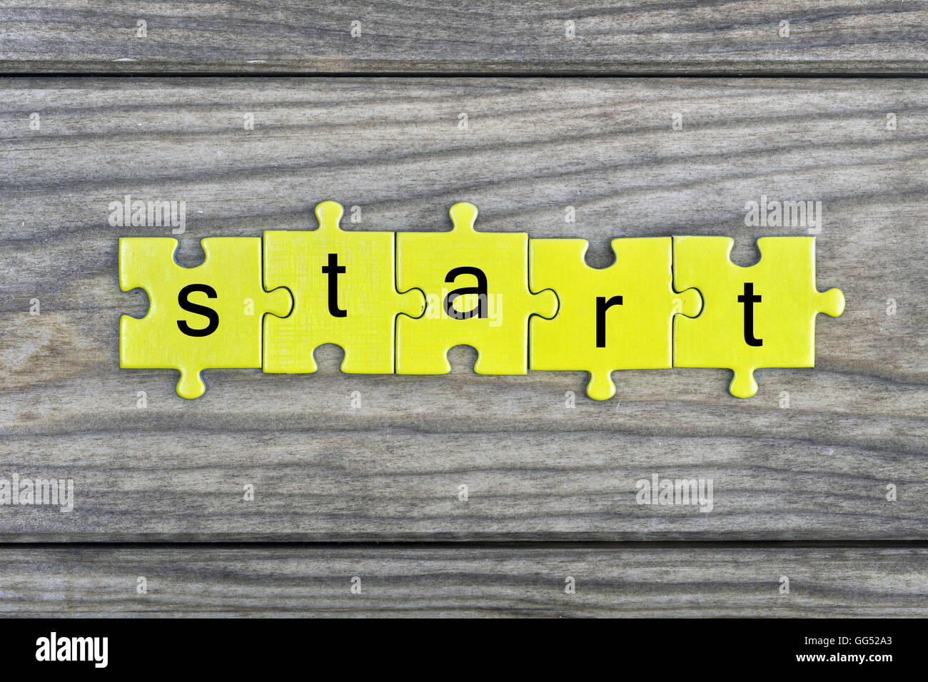 Puzzle pieces with word Start Stock Photo - Alamy