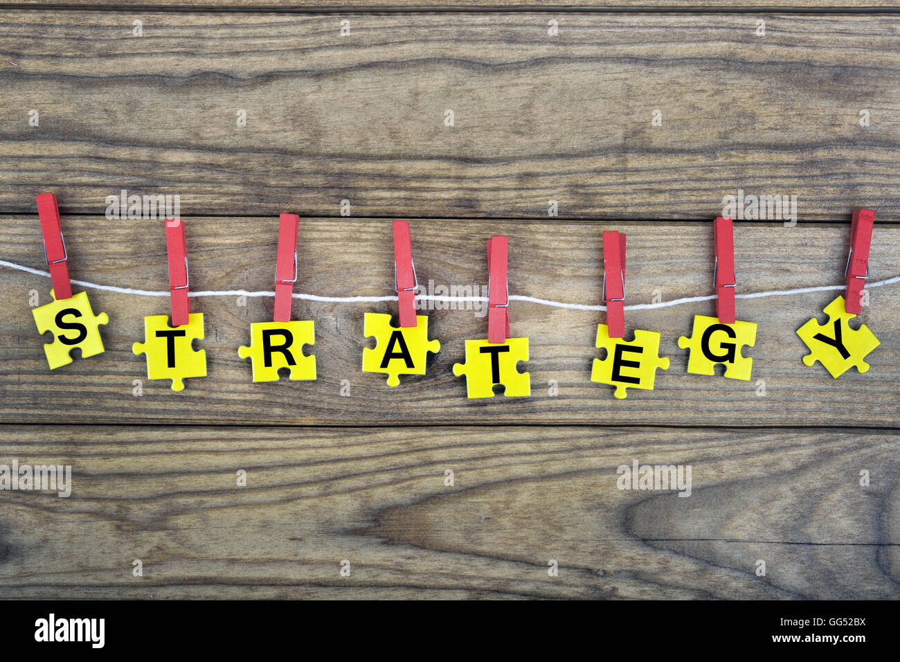Puzzle pieces with word Strategy Stock Photo - Alamy