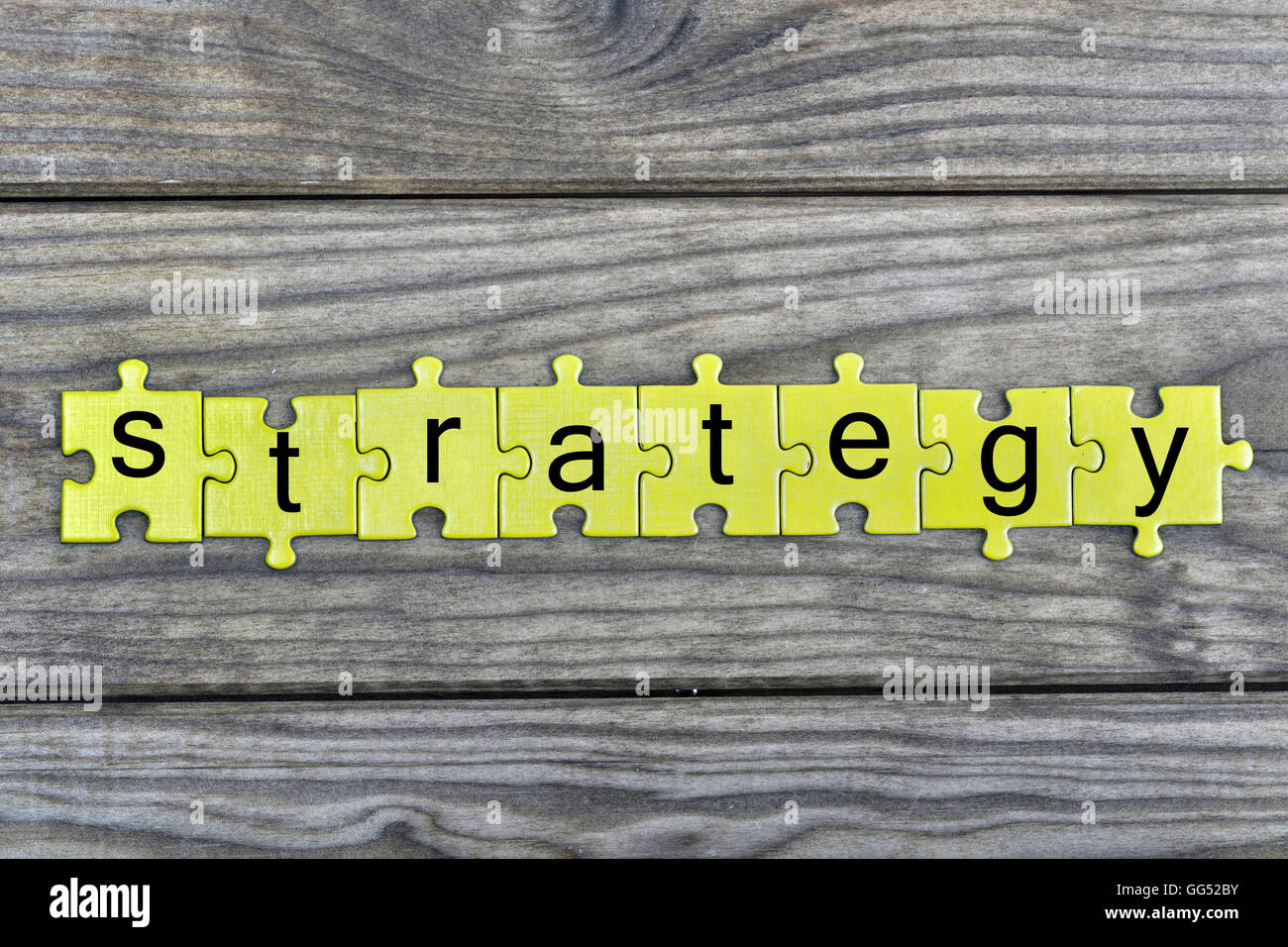 Puzzle pieces with word Strategy Stock Photo - Alamy