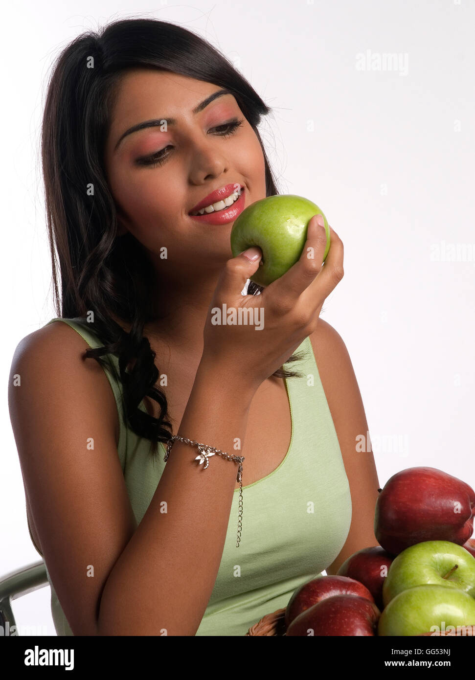 Woman about to eat an apple Stock Photo - Alamy
