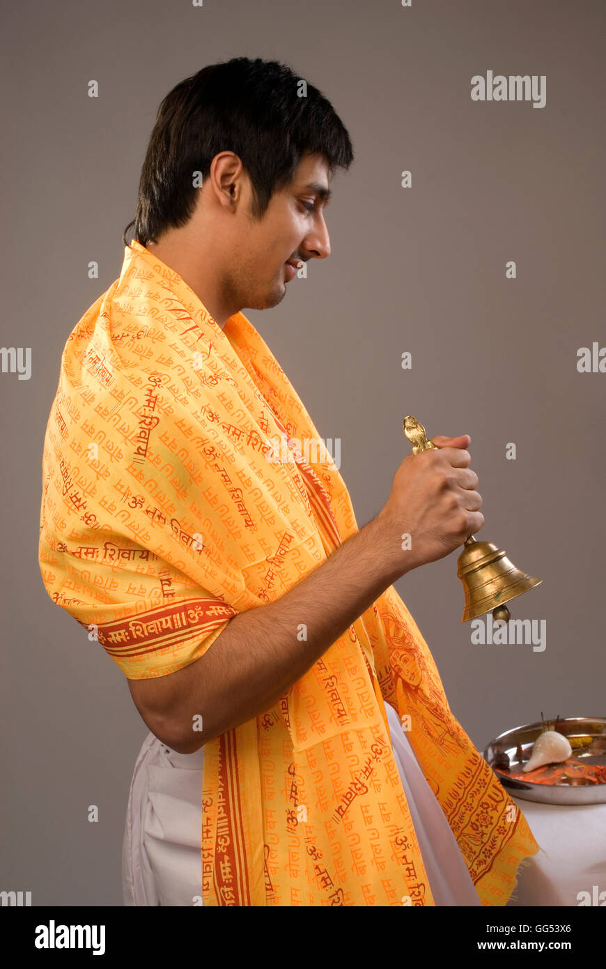 Man holding a prayer bell Stock Photo - Alamy