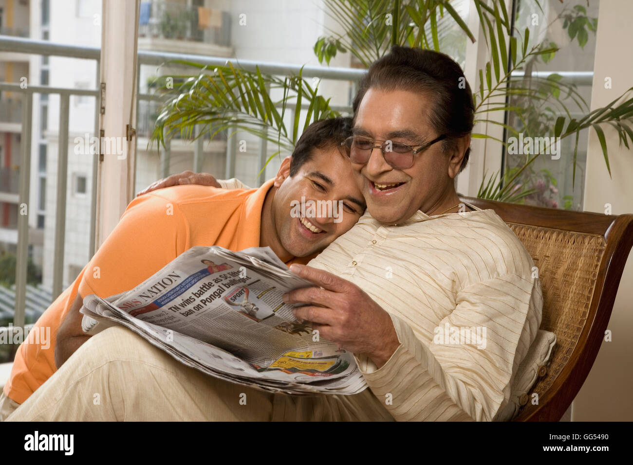 Father and son reading the newspaper Stock Photo - Alamy
