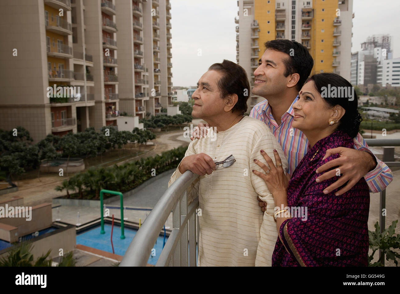 Man standing with his parents Stock Photo - Alamy