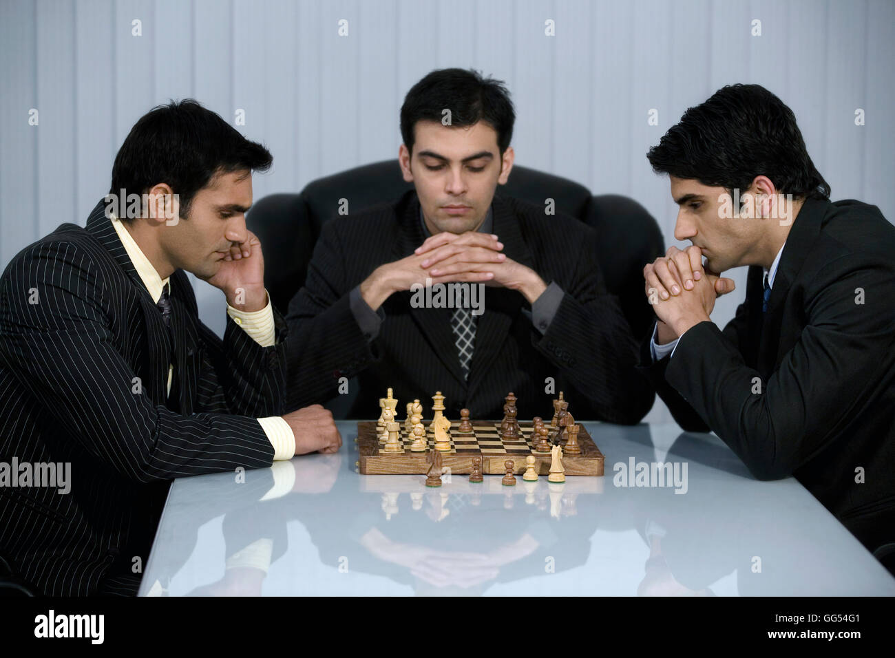 Three playing chess hi-res stock photography and images - Alamy