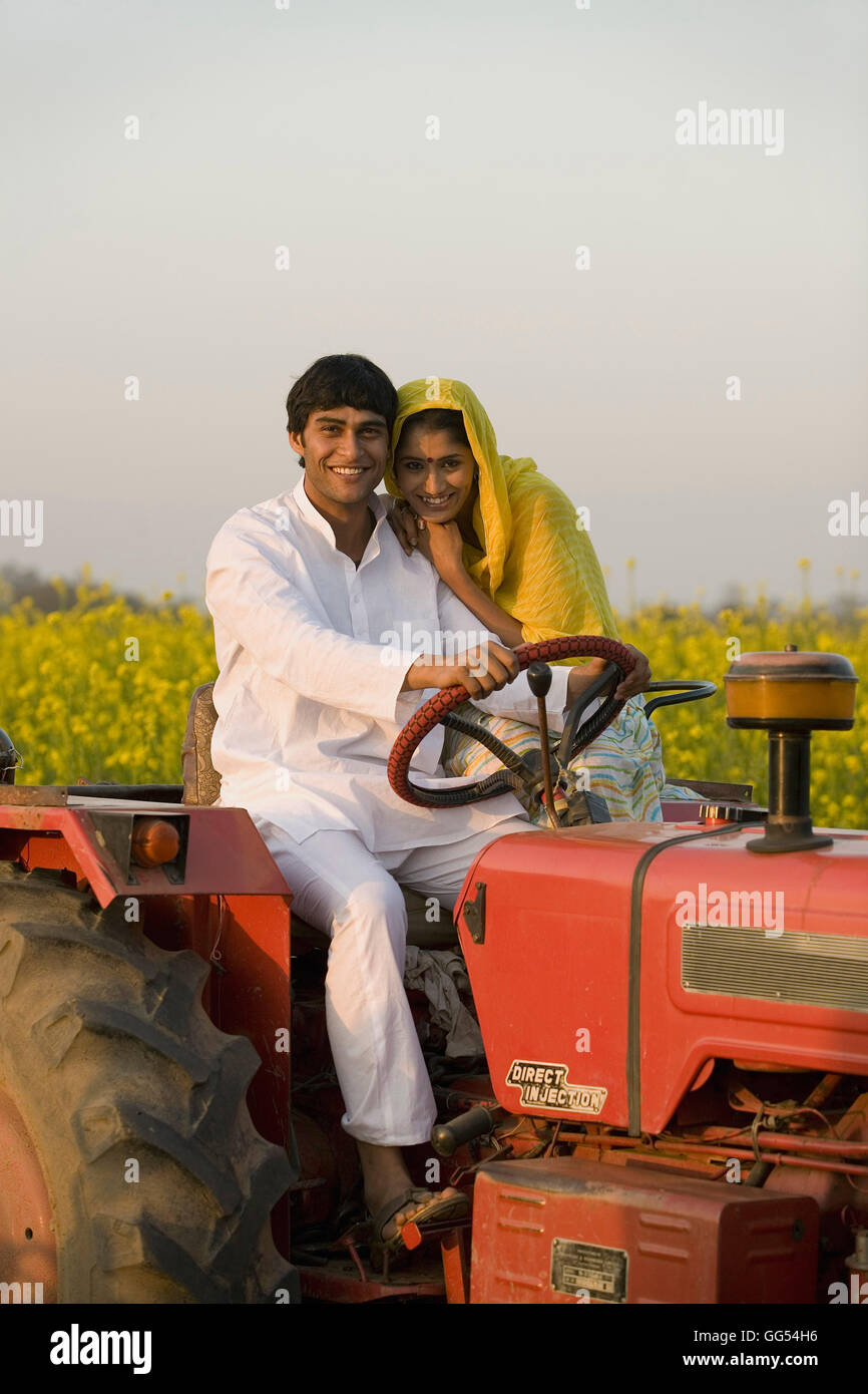 A rural couple on a tractor Stock Photo - Alamy