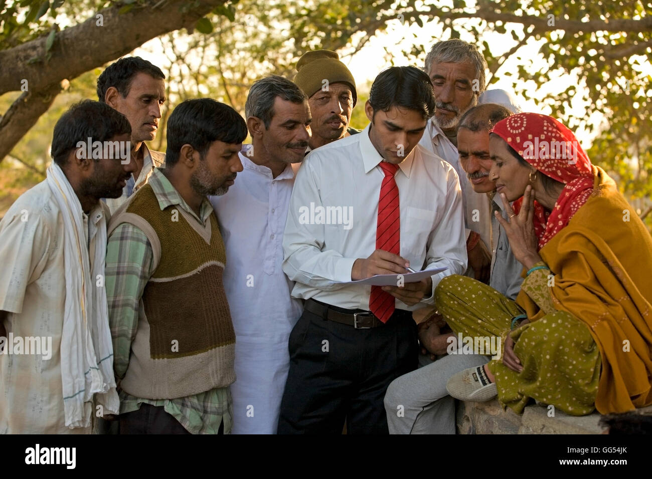 A man explaining to the rural people Stock Photo - Alamy
