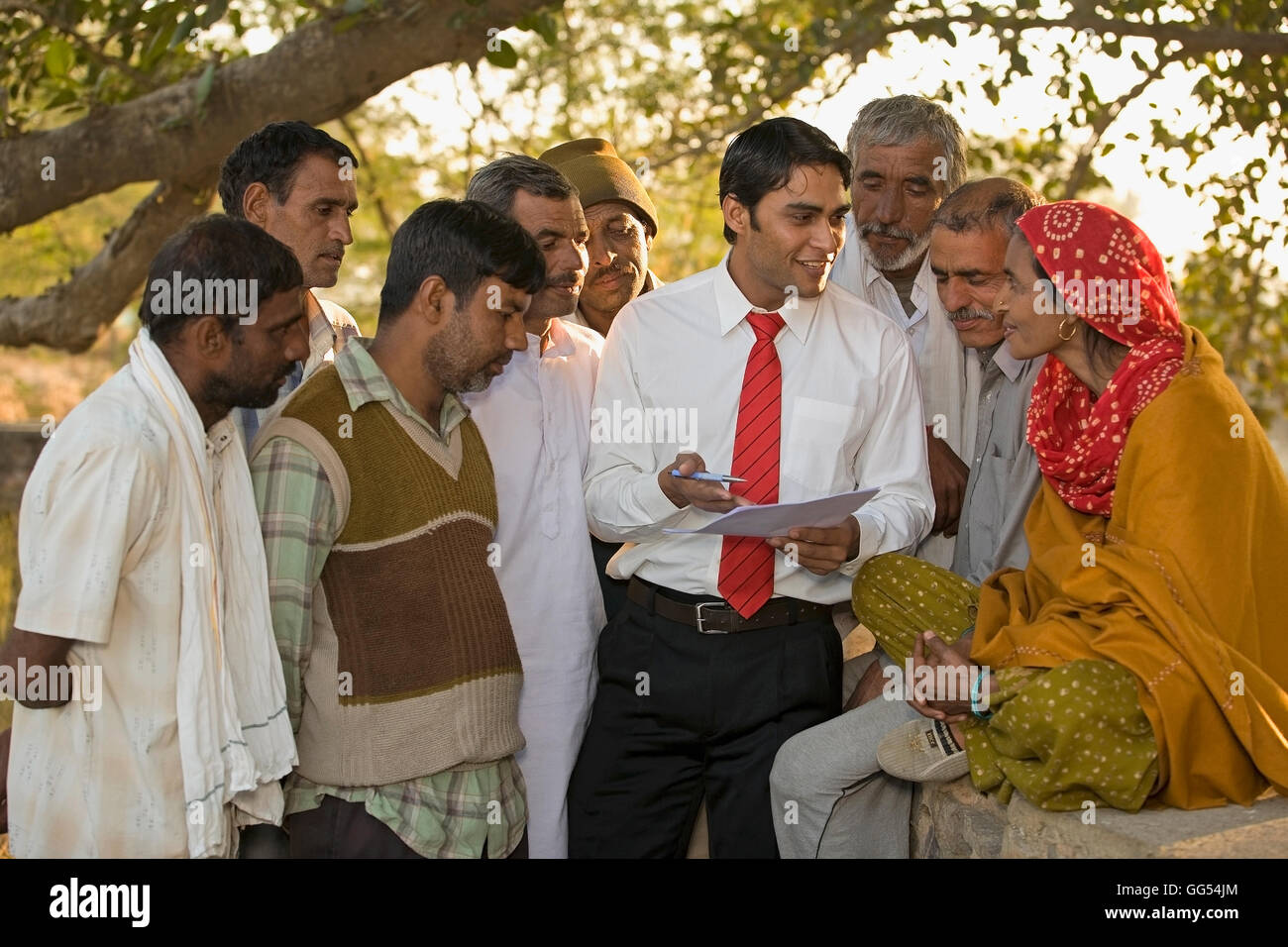 A man explaining to the rural people Stock Photo - Alamy