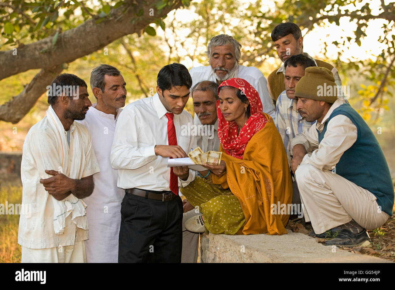 A man explaining to the rural people Stock Photo - Alamy