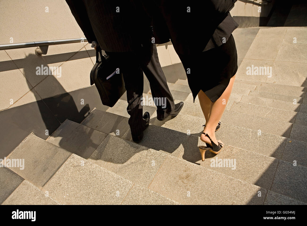Executives climbing down the stairs Stock Photo - Alamy