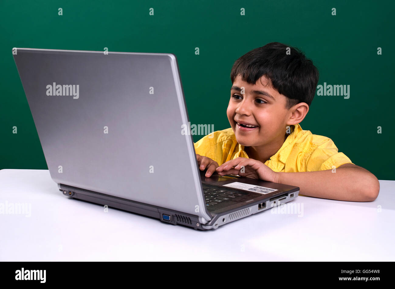 A boy working on a laptop Stock Photo - Alamy