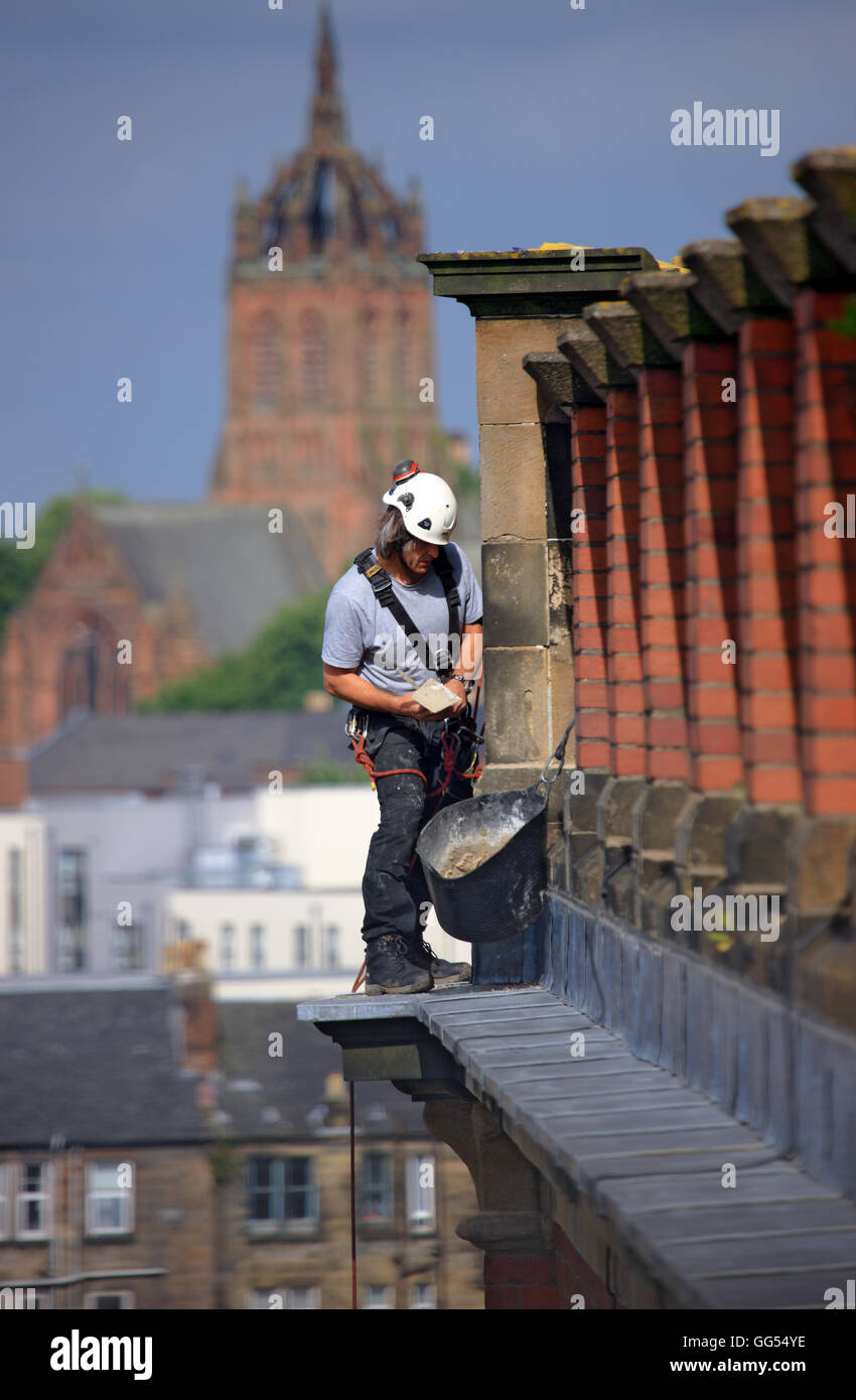 Abseiler working on pointing stonework on a building in Paisley ...