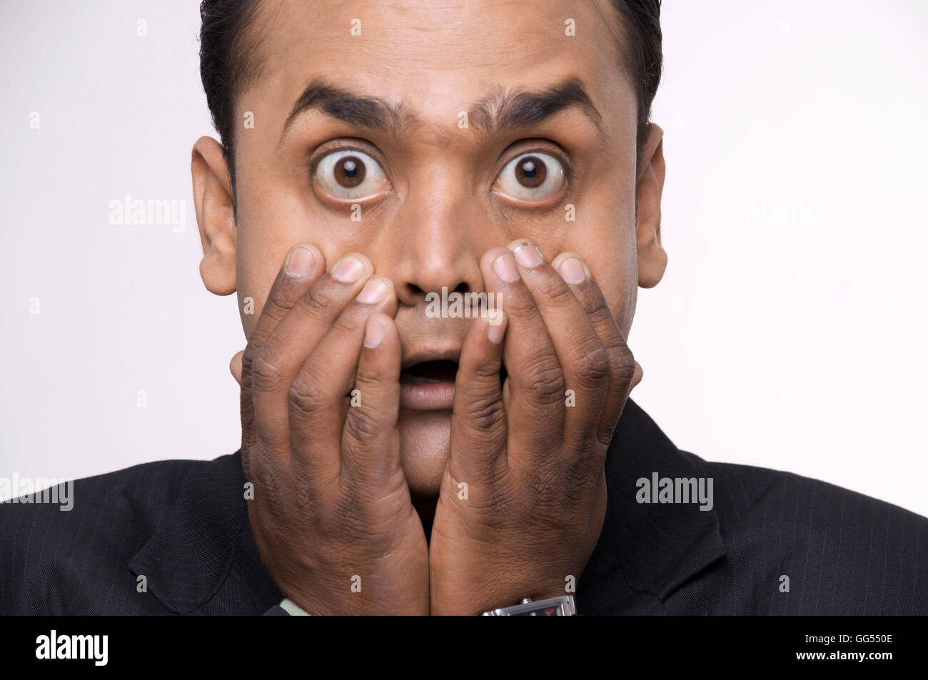 An executive clutching his face Stock Photo - Alamy