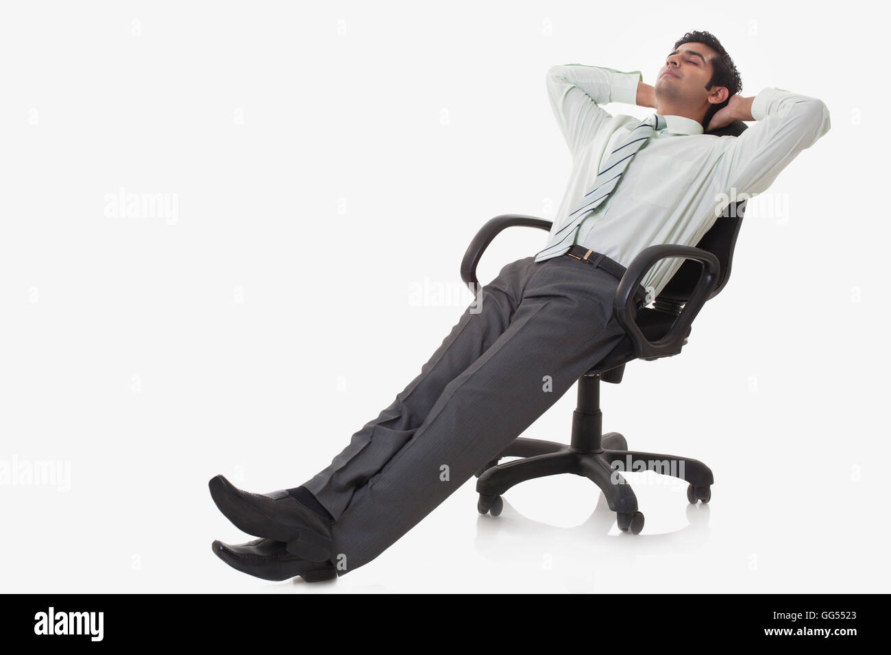 Indian man relaxing on chair Cut Out Stock Images & Pictures - Alamy