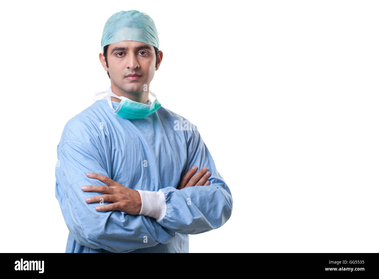 Portrait of male surgeon with hands folded over white background Stock ...