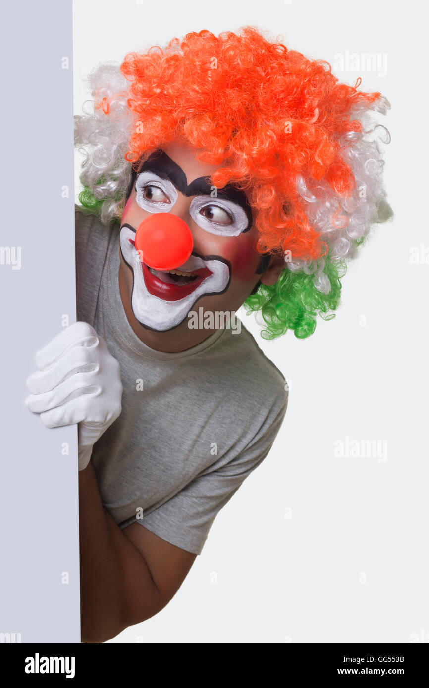 Young male clown hiding behind hi-res stock photography and images - Alamy