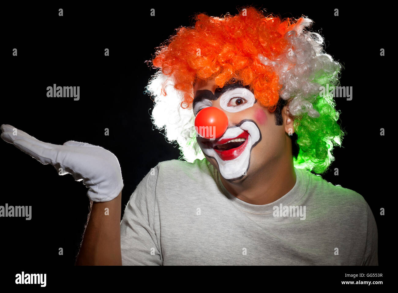 Portrait of male clown gesturing on black background Stock Photo - Alamy