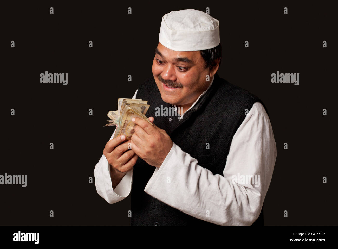 Indian politician taking bribes over black background Stock Photo - Alamy