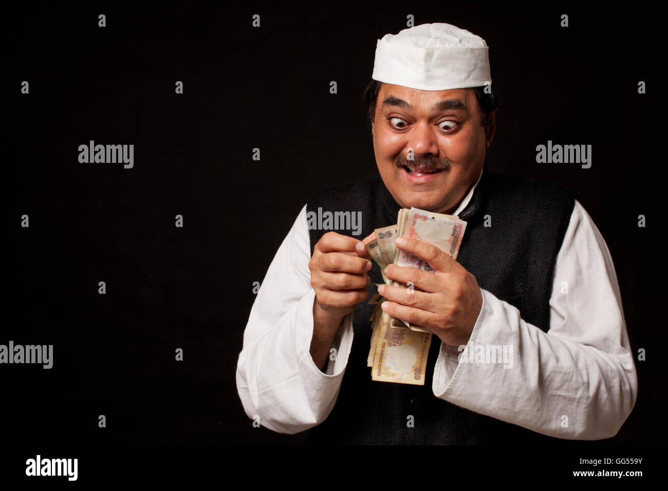 Greedy mature politician counting money over black background Stock ...