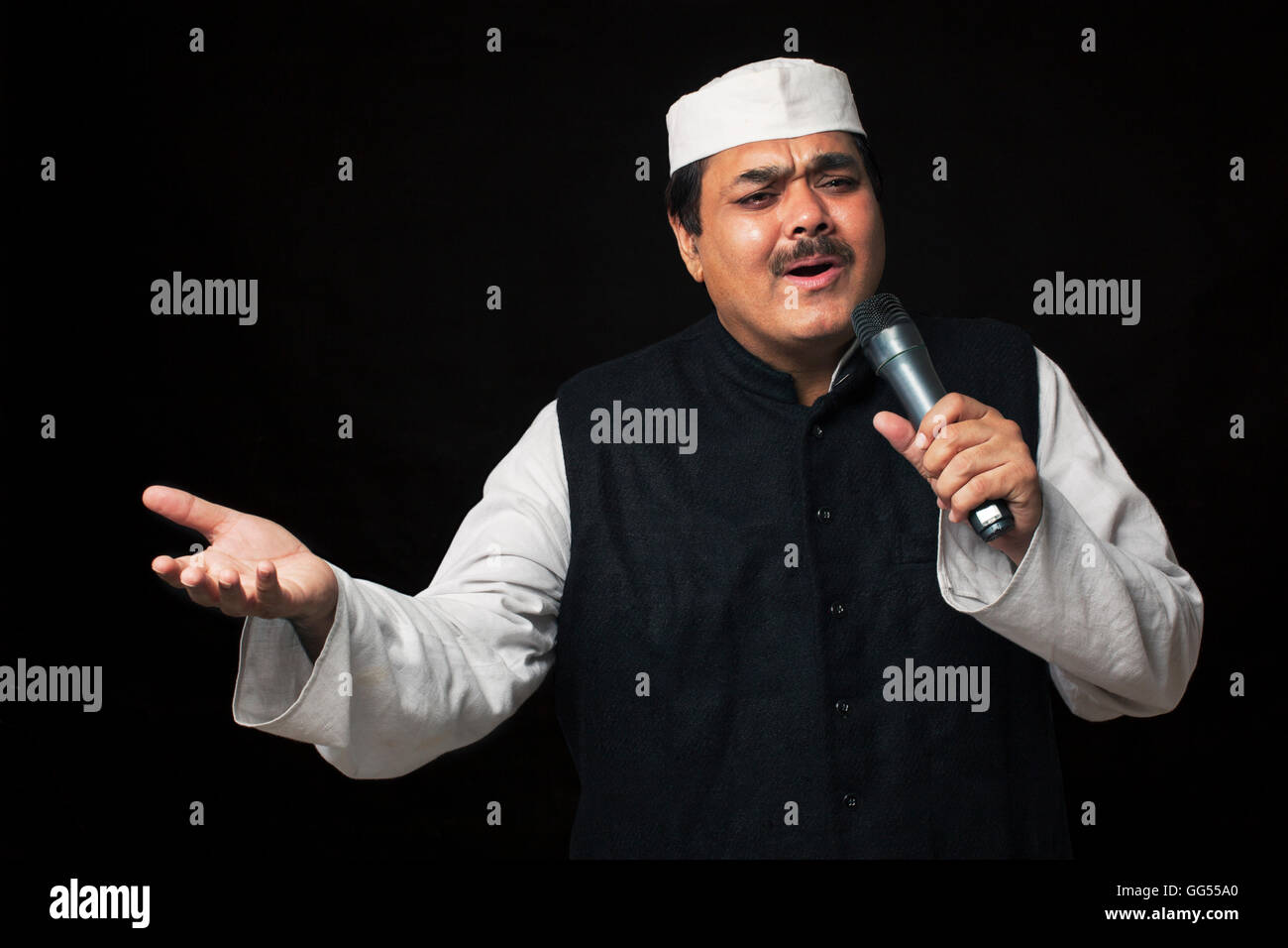 Male politician talking on a microphone Stock Photo - Alamy