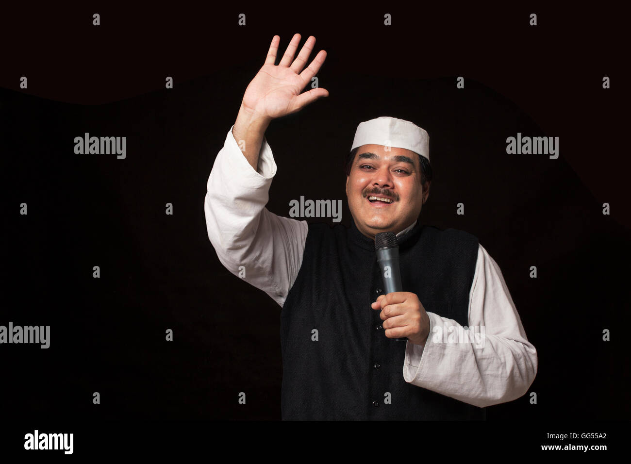 Male politician with microphone waving Stock Photo - Alamy