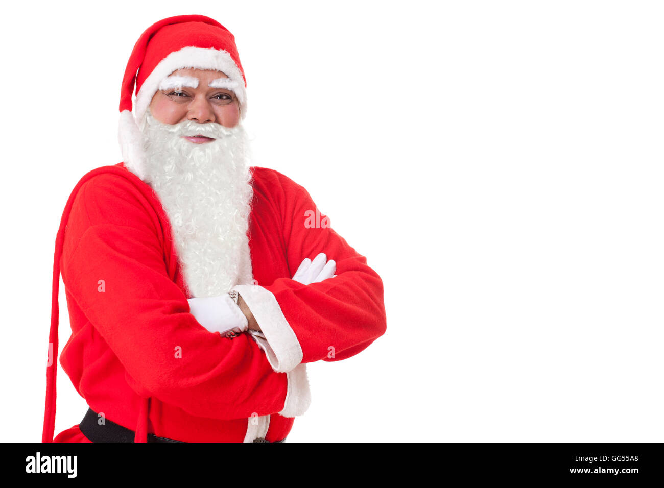 Smiling Santa Claus with arms folded over white background Stock Photo ...